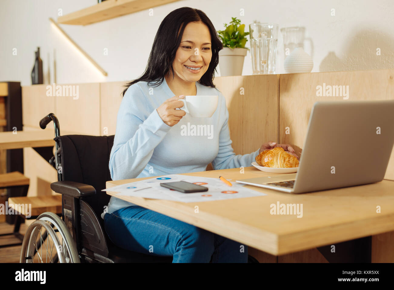 Inspired disabled woman working on her laptop Stock Photo - Alamy