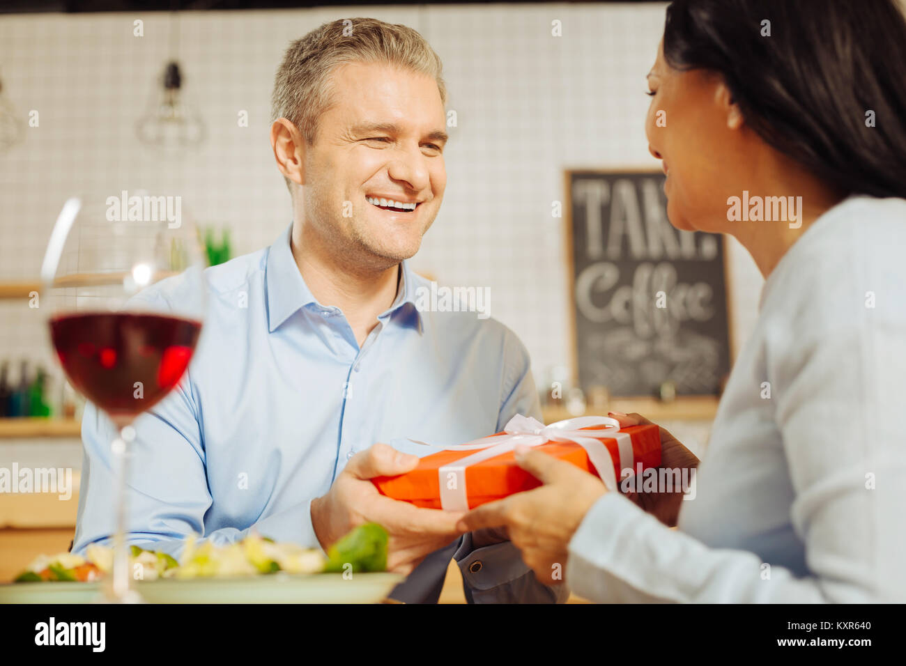Content man giving present to his beloved woman Stock Photo - Alamy