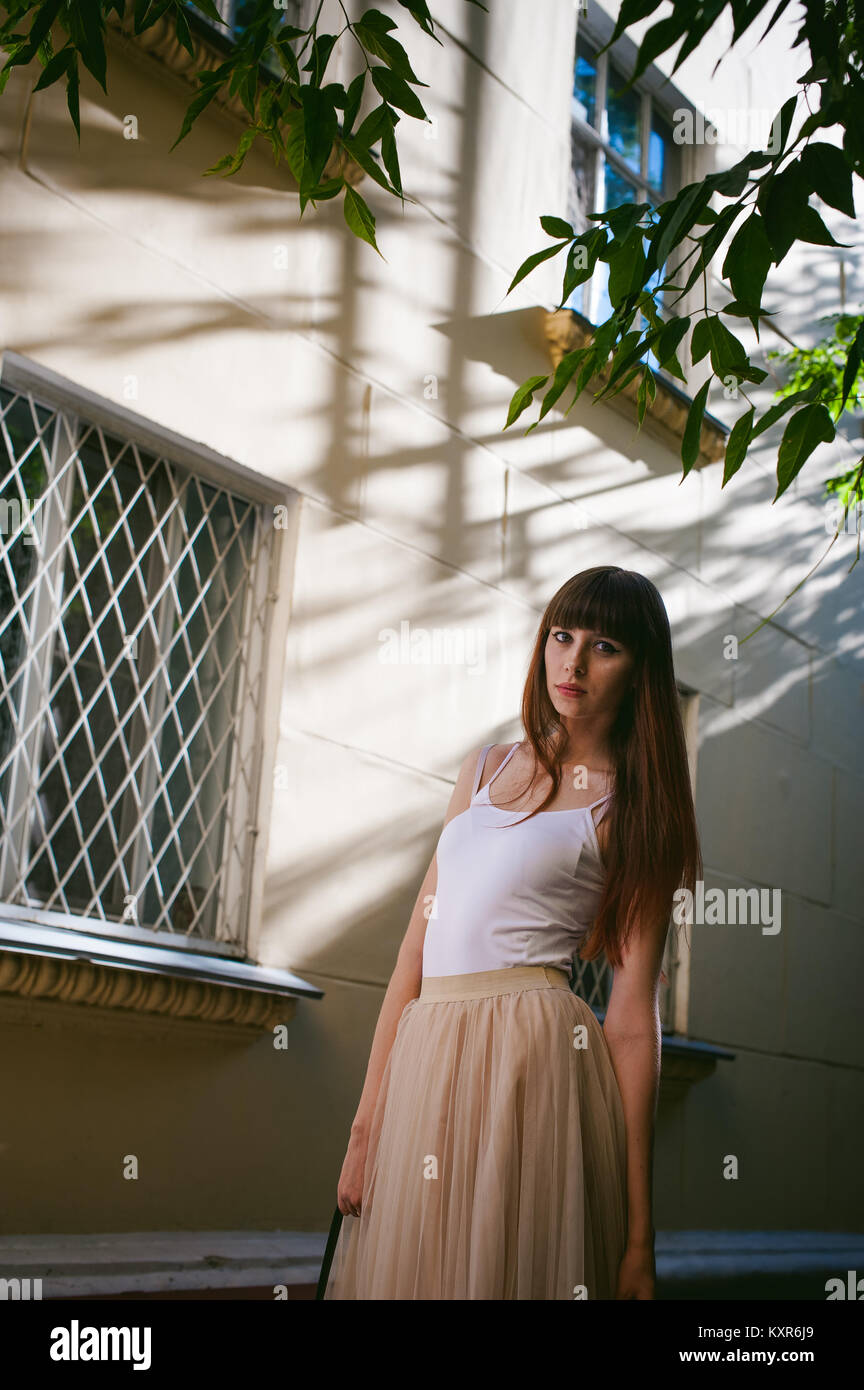 Young beautiful woman walking around the street on a warm sunny summer ...