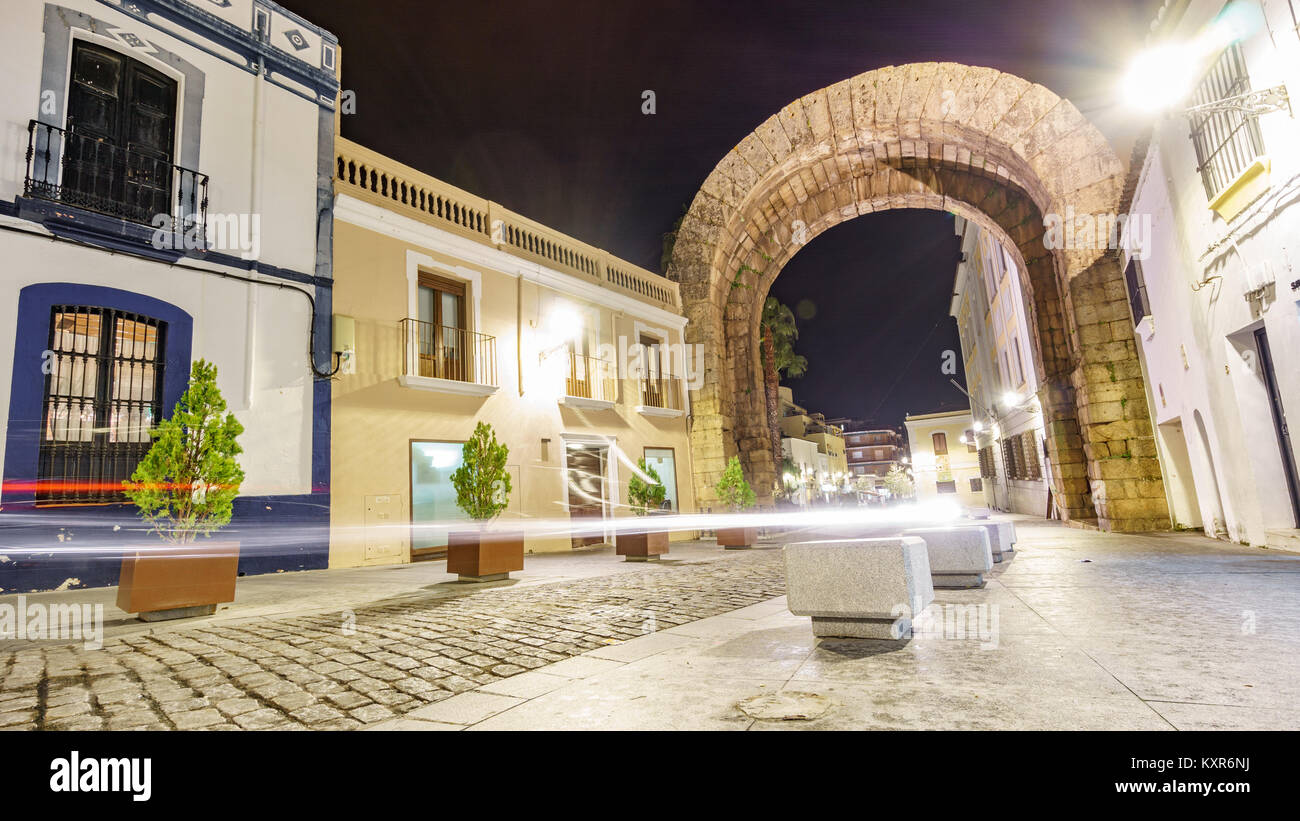 Trajano Arch at night with car light trail in Merida Stock Photo - Alamy