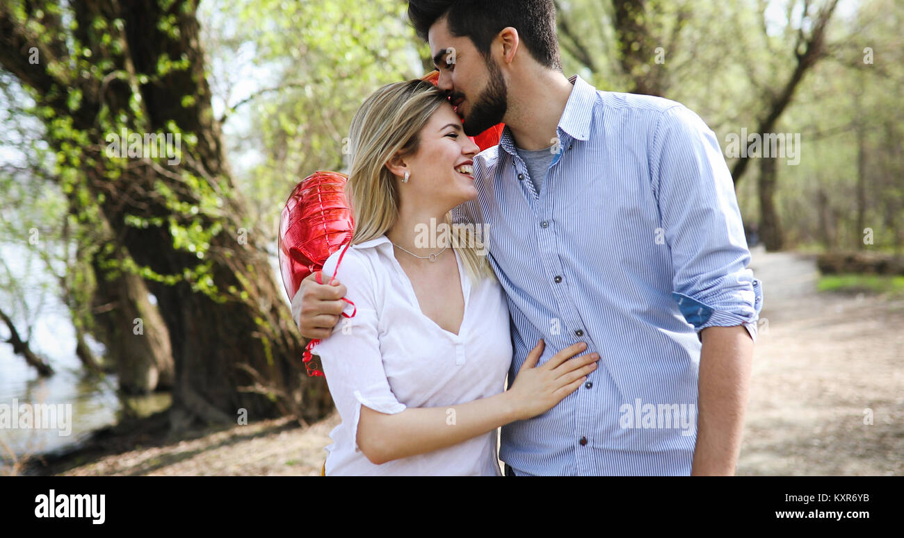 Picture of romantic couple standing outside with baloons Stock Photo ...