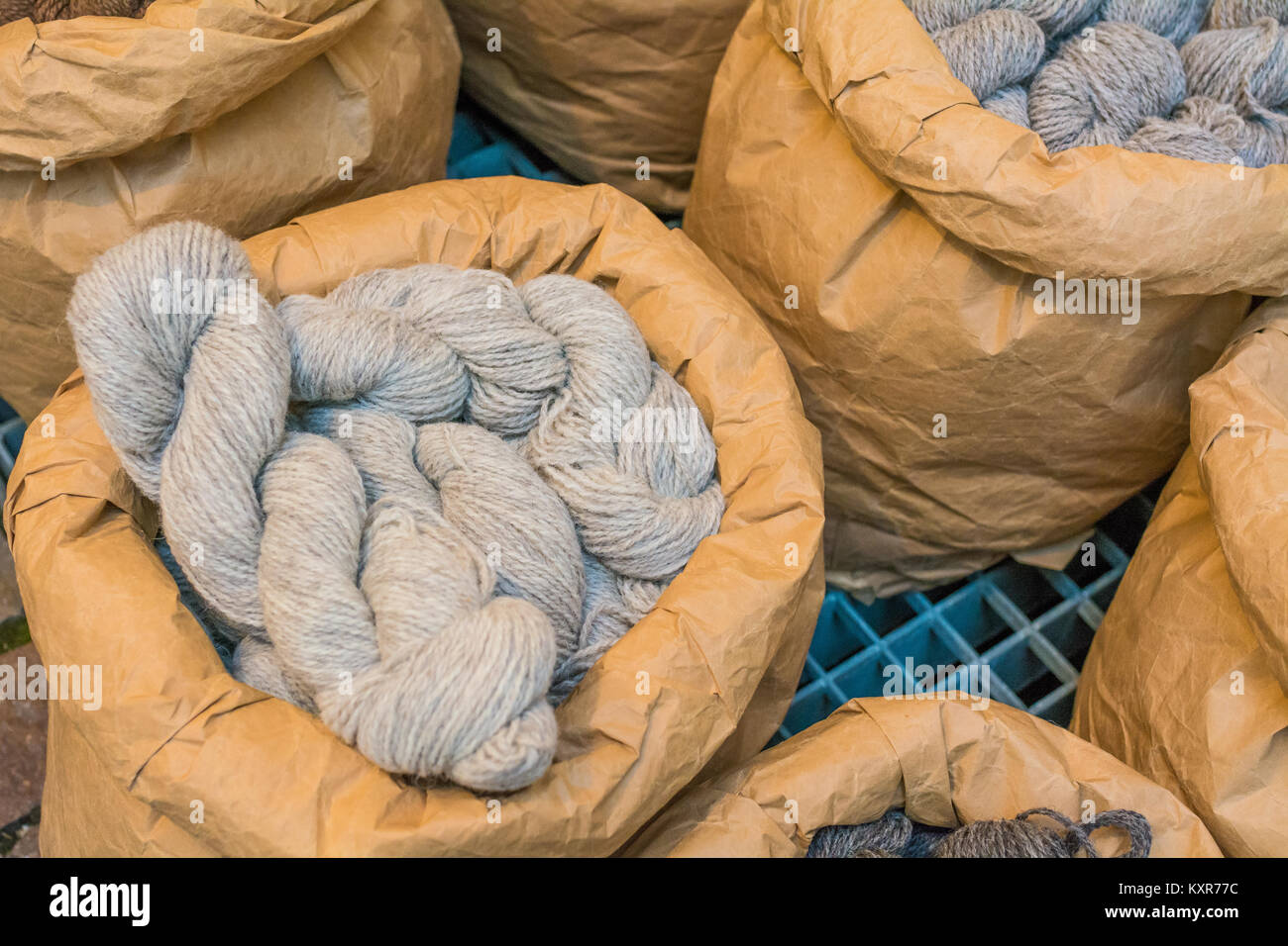 Grey wool yarn in raw paper containers. Boiled Wool Stock Photo - Alamy