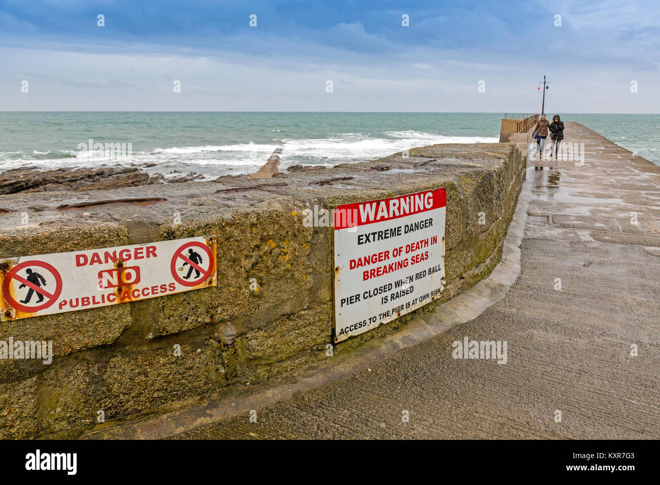 Warning signs on the breakwater at the harbour entrance at Porthleven ...