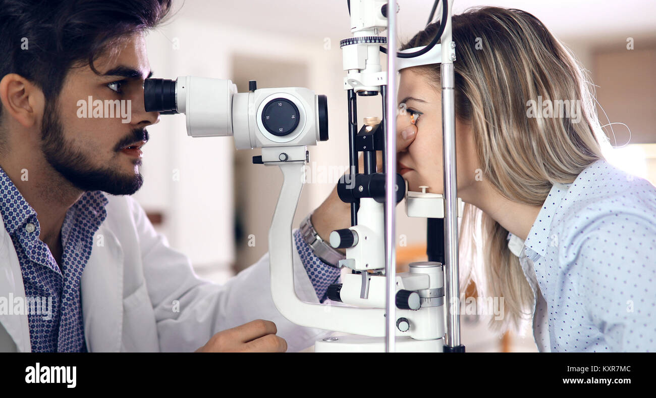 Optometrist examining patient in modern ophthalmology clinic Stock ...