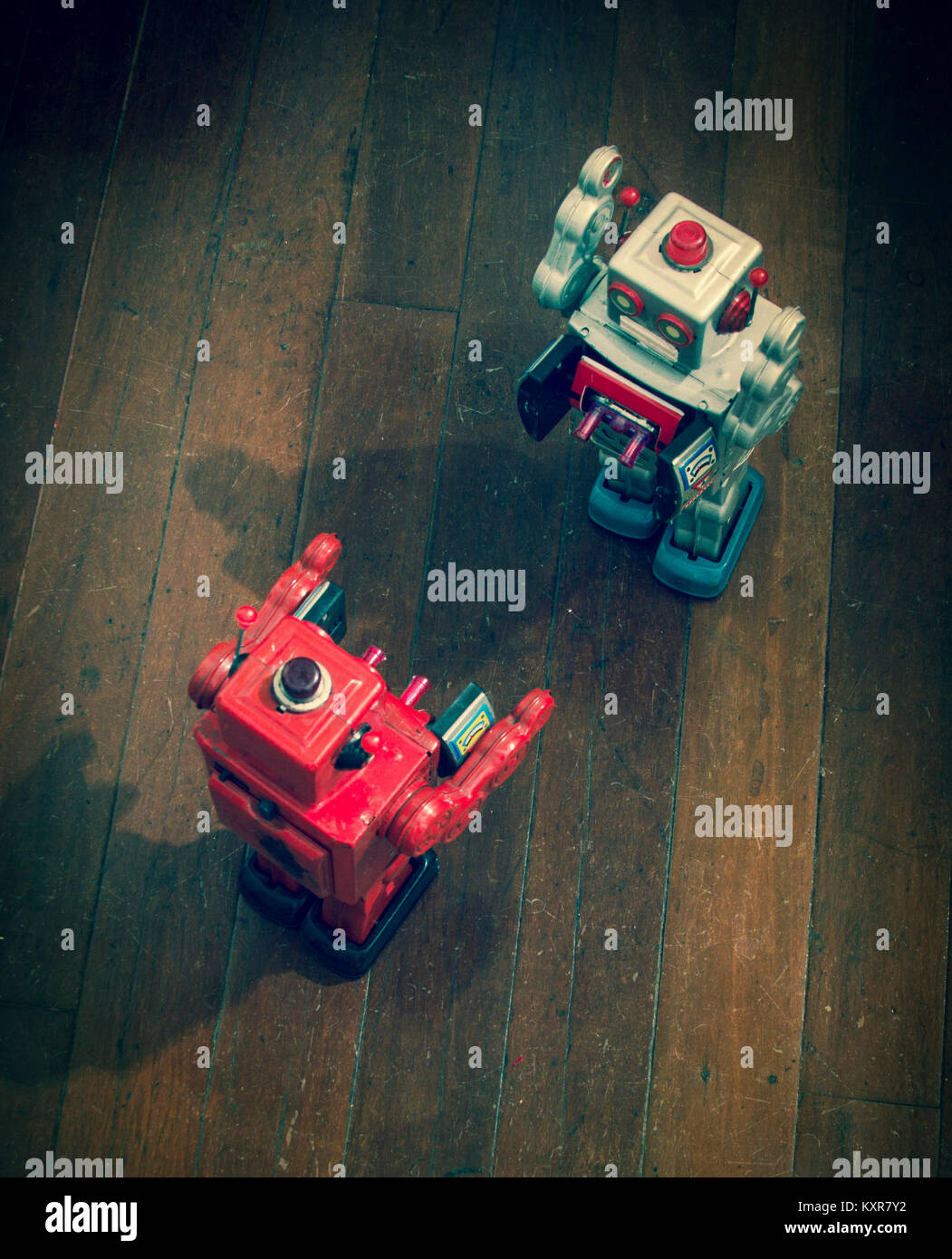 two retro robots fight on a wooden floor shot from above Stock Photo ...