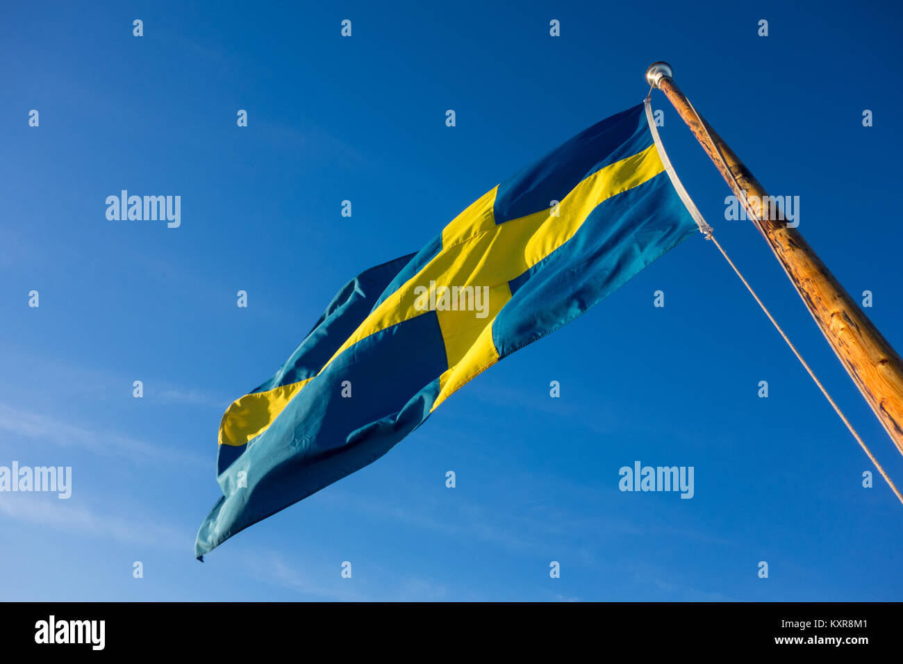 Swedish flag blowing in the wind against clear blue sky, Stockholm ...