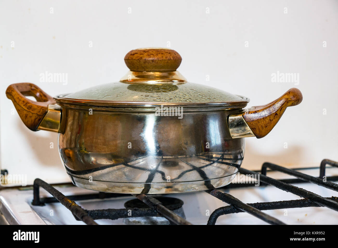A small silver Pot on a gas stove Stock Photo - Alamy