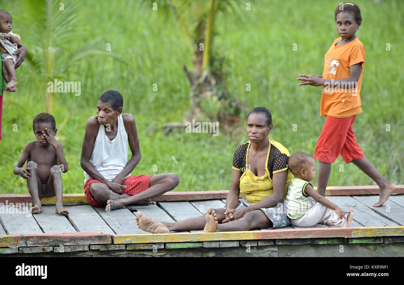 Asmat people in small deaf traditional village in jungle of New Guinea ...