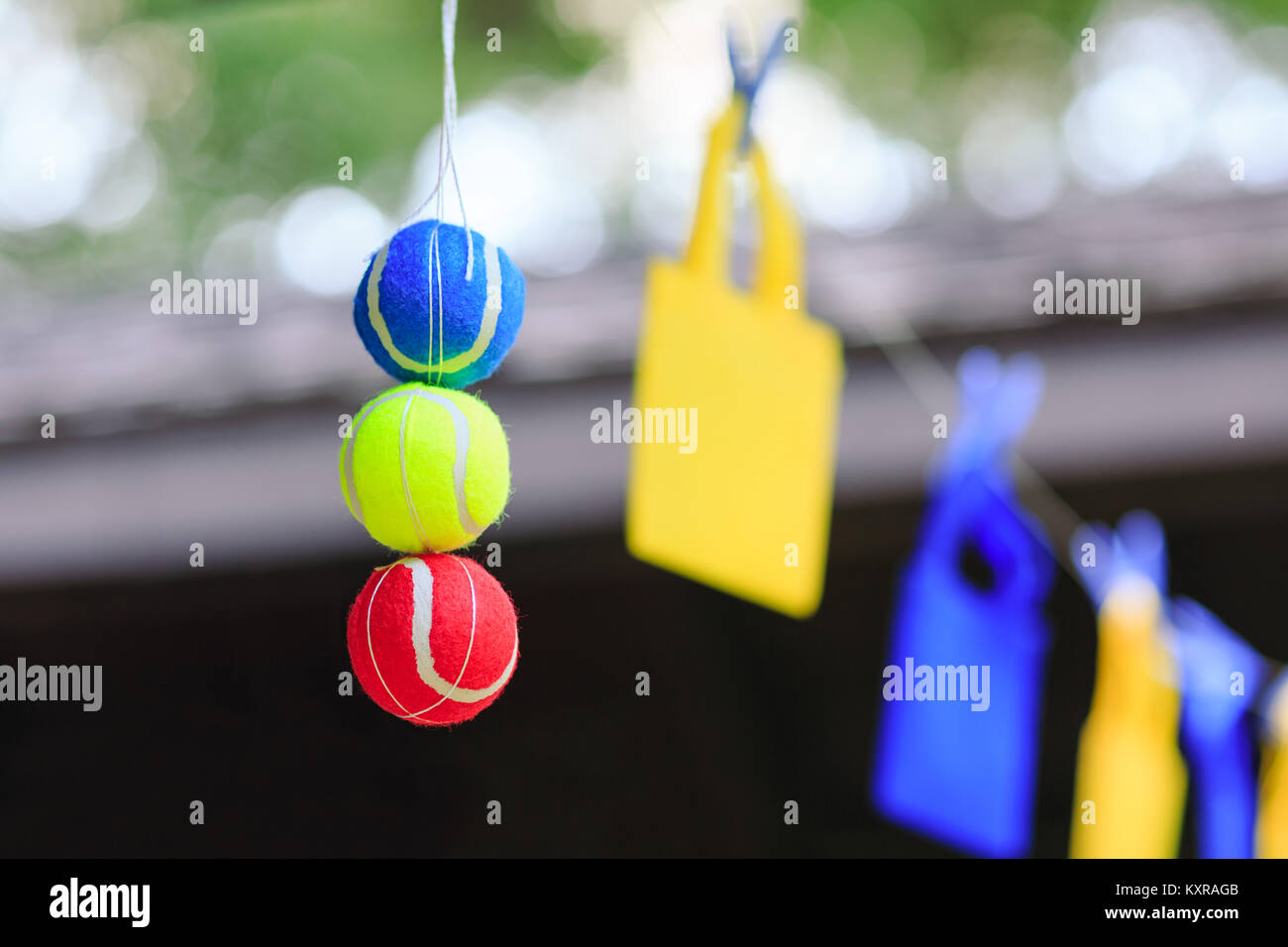 Set of tennis balls hanging from the thread. Isolated in tricolor ...