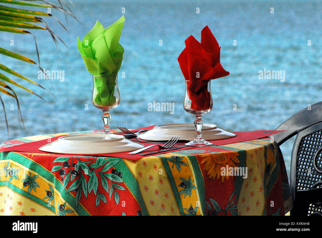 A colorful, romantic, set table by the sea, on the Caribbean island of ...