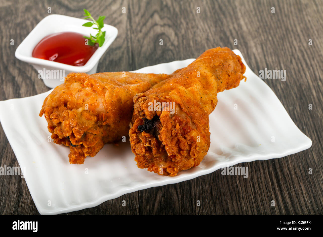 Crispy chicken legs with ketchup Stock Photo - Alamy
