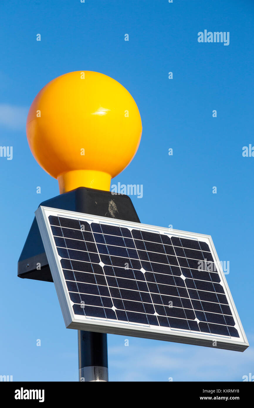 A pedestrian crossing light powered by a solar panel in a supermarket ...