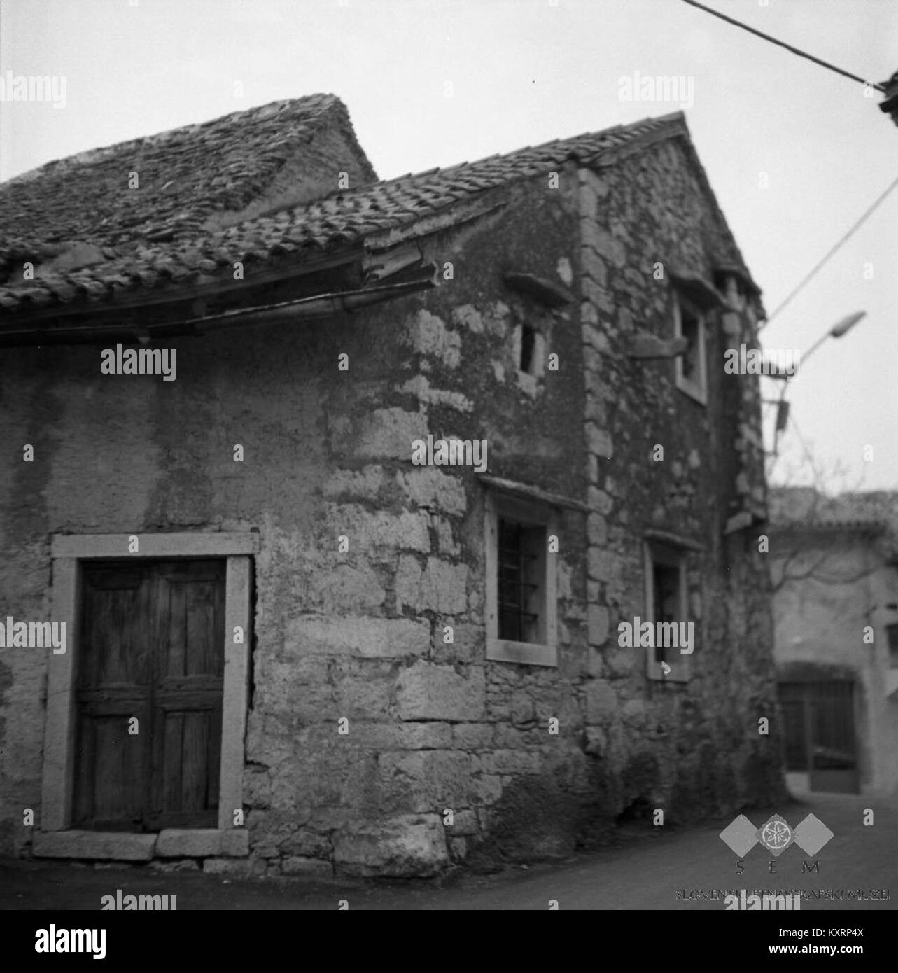 This image depicts a facade of a rural farmhouse ('kmecke hise') in ...