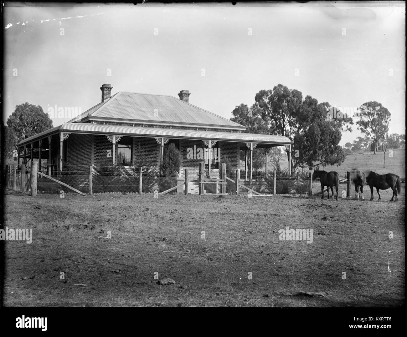 A rural scene featuring a country cottage with a veranda, accompanied ...