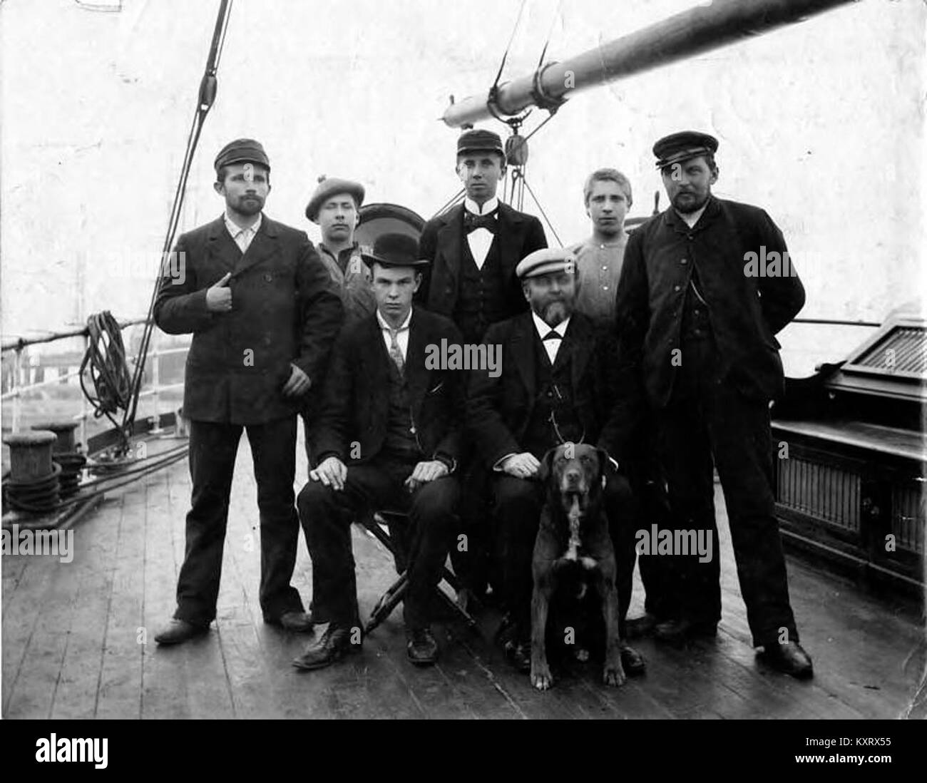 A circa 1900 image of sailors working on the deck of a ship docked in ...