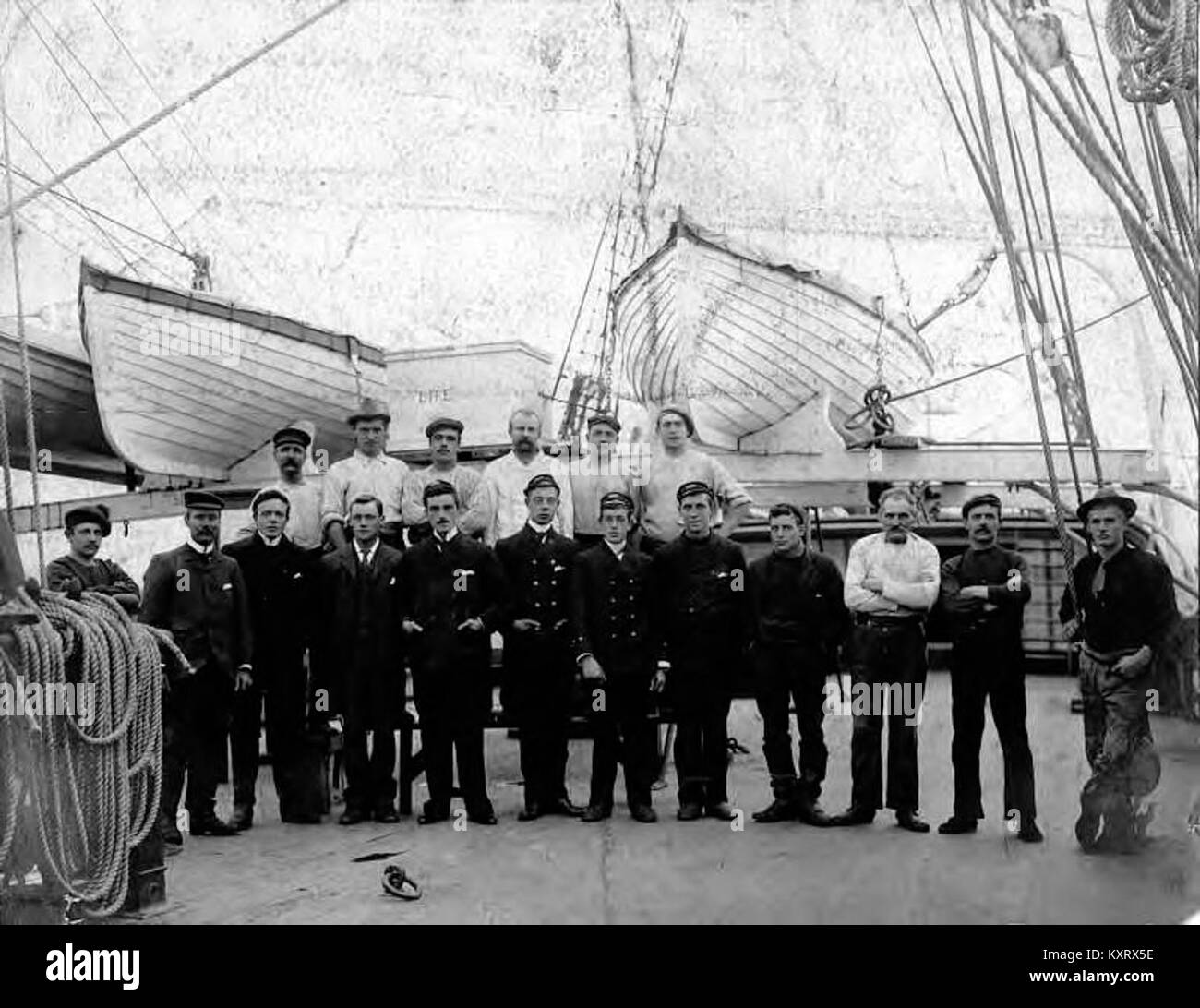 This historical photograph shows the crew aboard an unidentified ship ...
