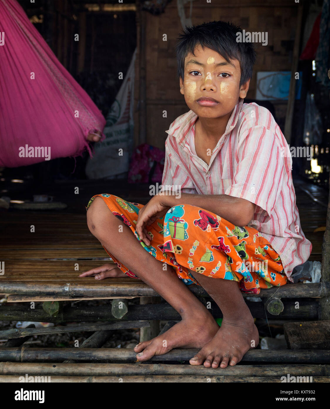 Boy sitting outside his house, Myanmar Stock Photo - Alamy