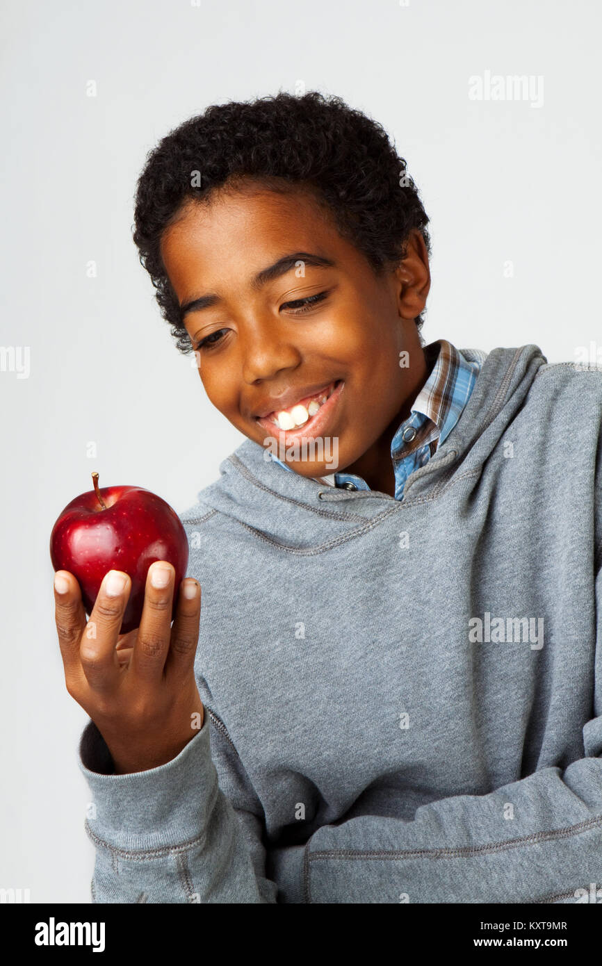 Young kid eating an apple Stock Photo - Alamy