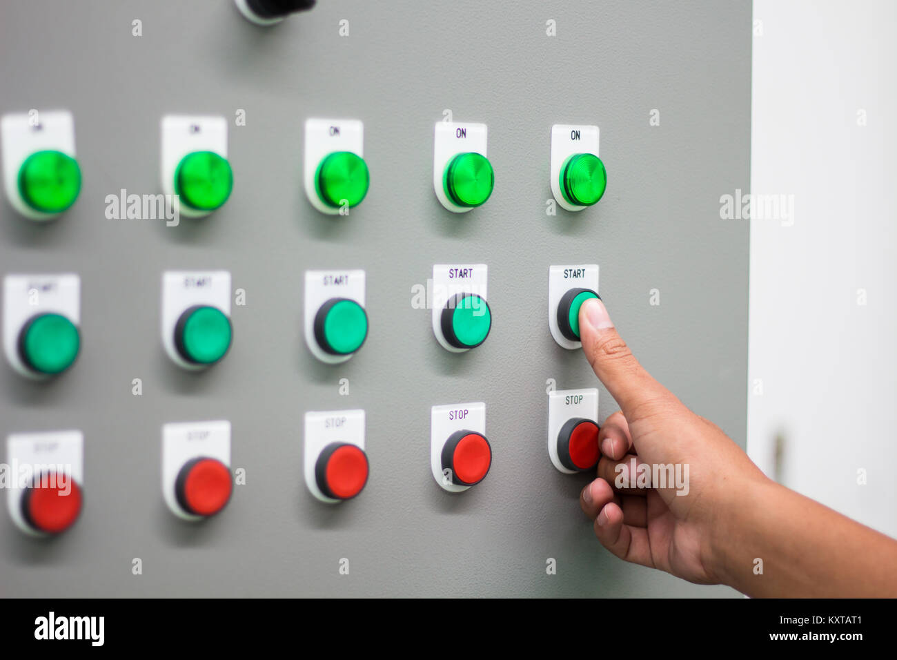 The hand pressing "START" switch on control board Stock Photo - Alamy