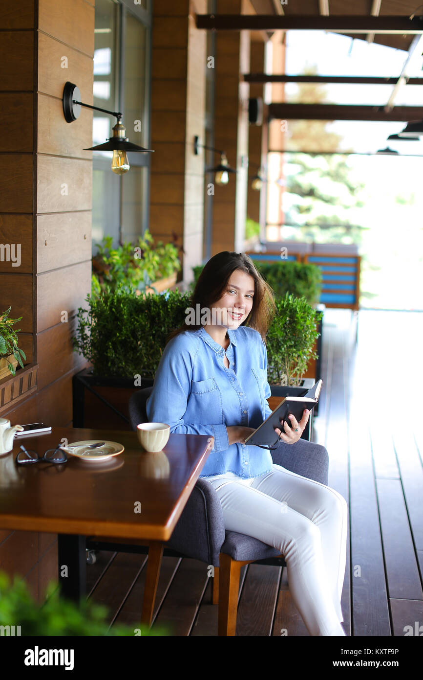 Beautiful girl reading diary at cafe Stock Photo - Alamy