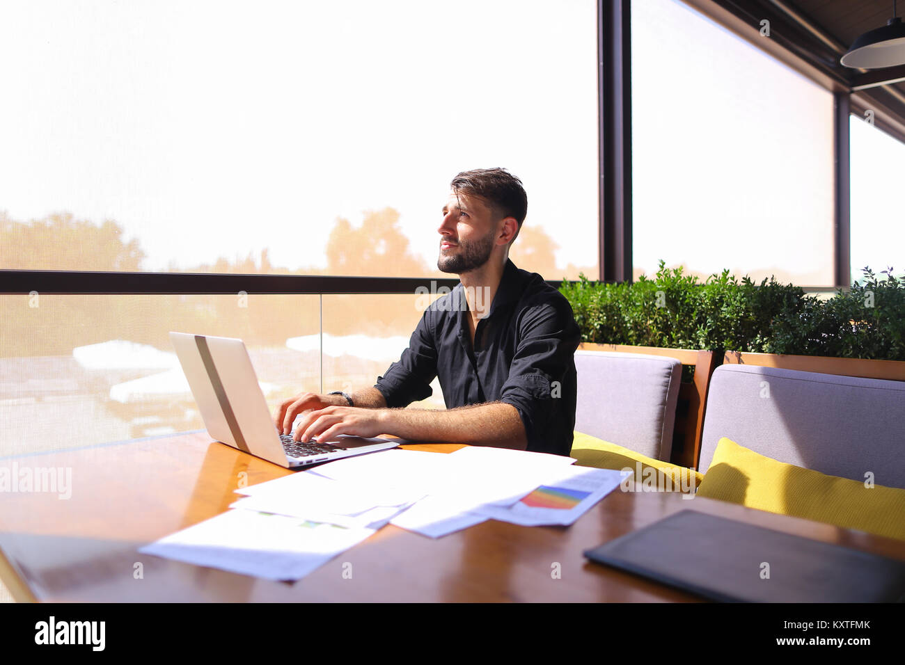 Office worker sorting papers on table near laptop Stock Photo - Alamy