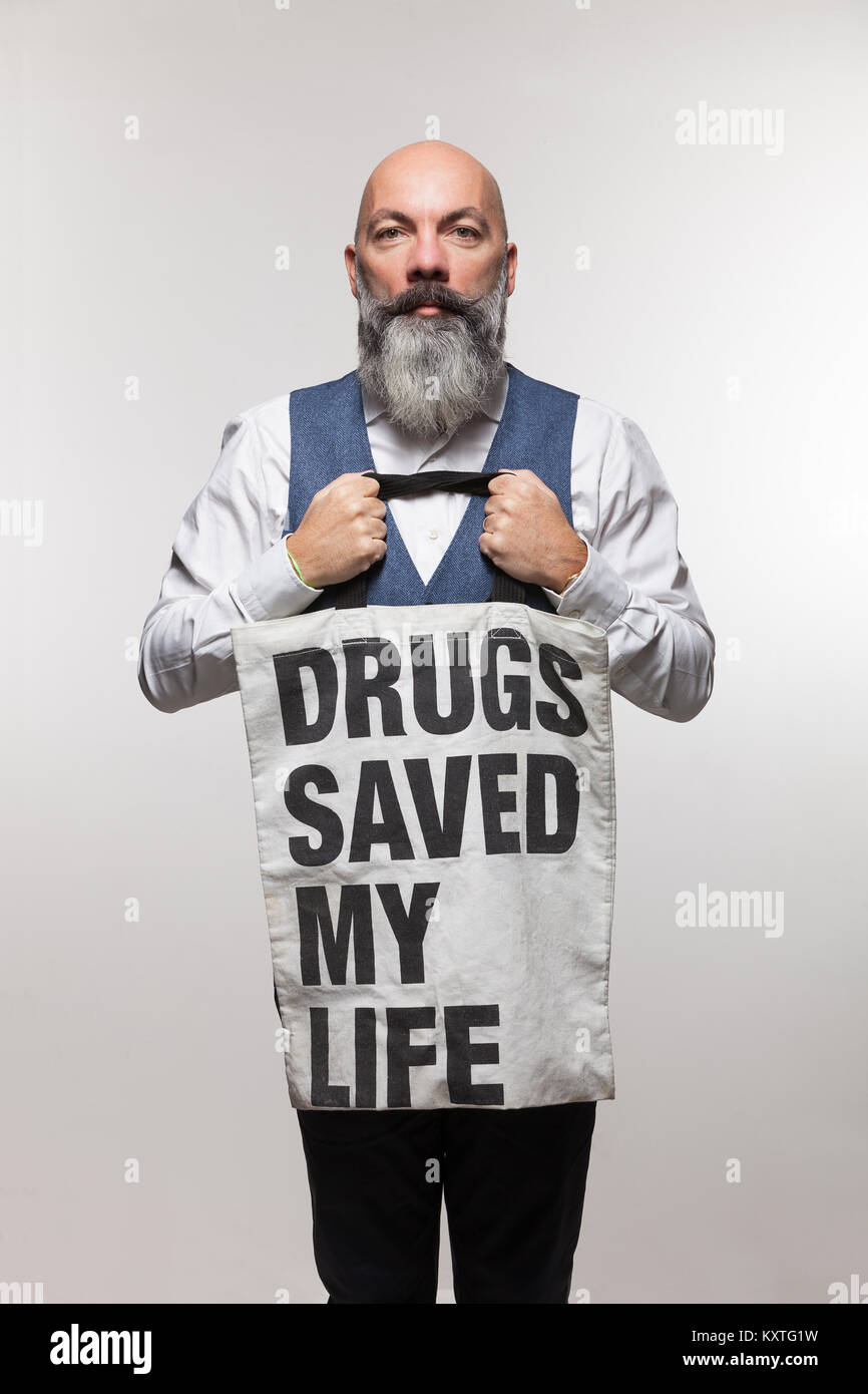 Man shows a bag with slogan, studio portrait. Drugs saved my life Stock ...