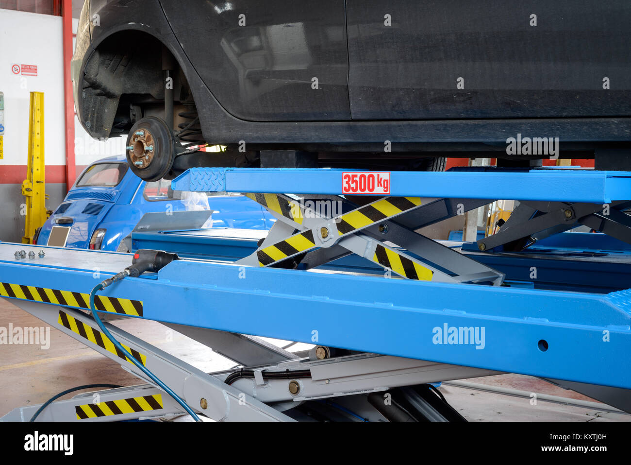 A car ready for fix on a workshop bridge, brakes are visible Stock ...