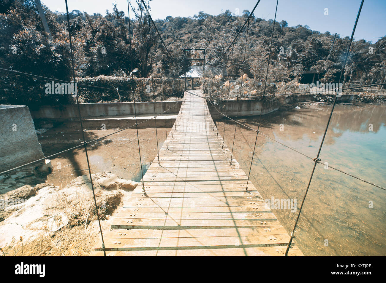 Wire hanging bridge with wooden pathway in Thailand Stock Photo - Alamy