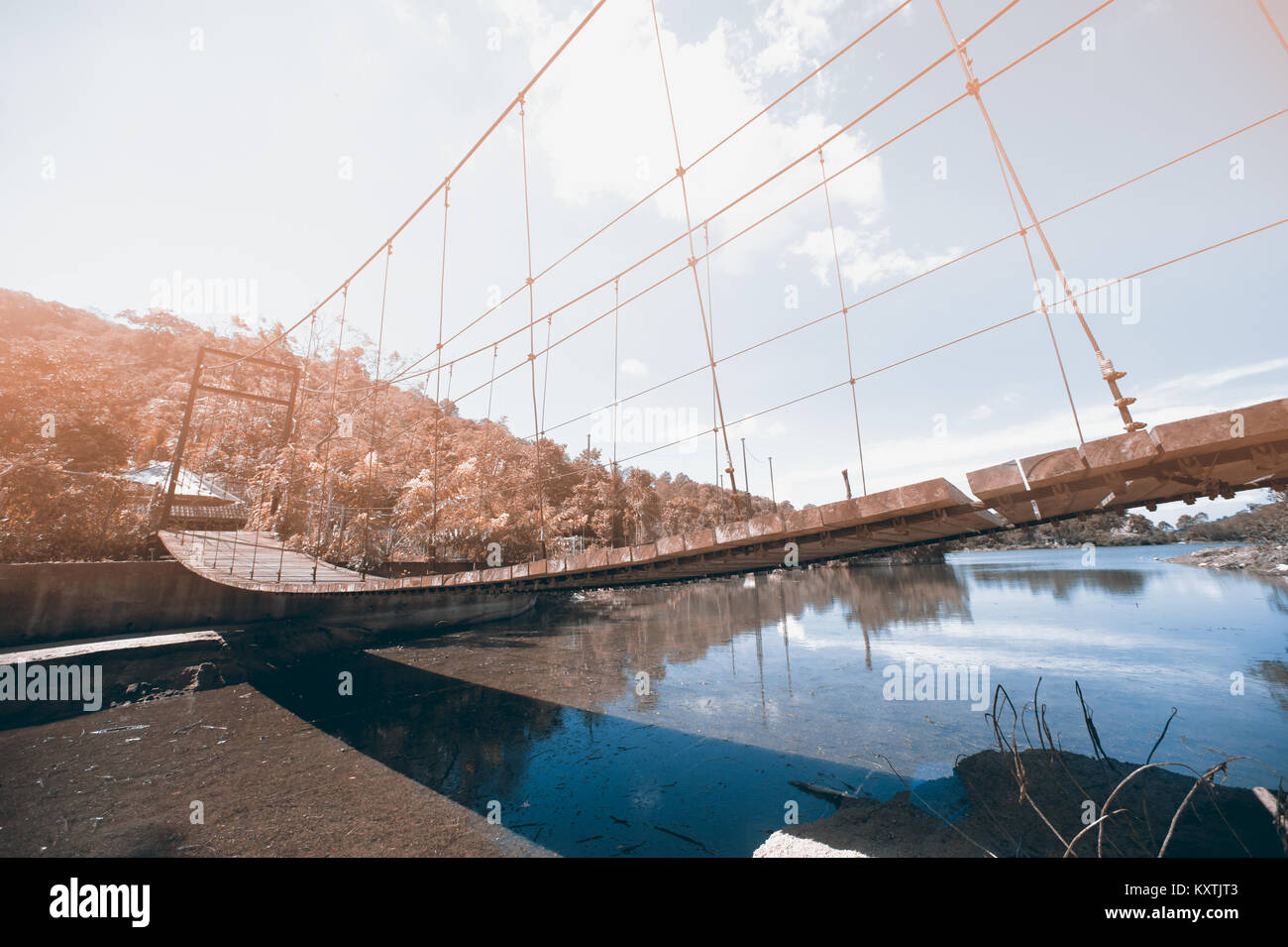 Wire hanging bridge with wooden pathway in Thailand Stock Photo - Alamy