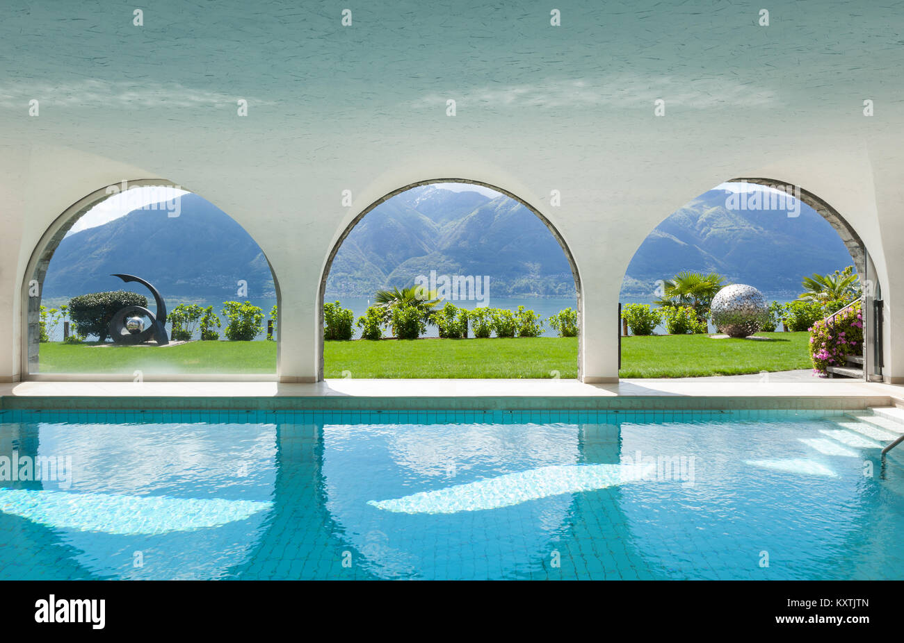 Luxury villa with indoor swimming pool, arched windows Stock Photo - Alamy