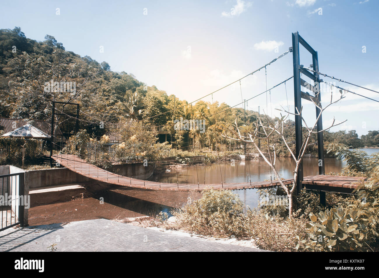 Wire hanging bridge with wooden pathway in Thailand Stock Photo - Alamy
