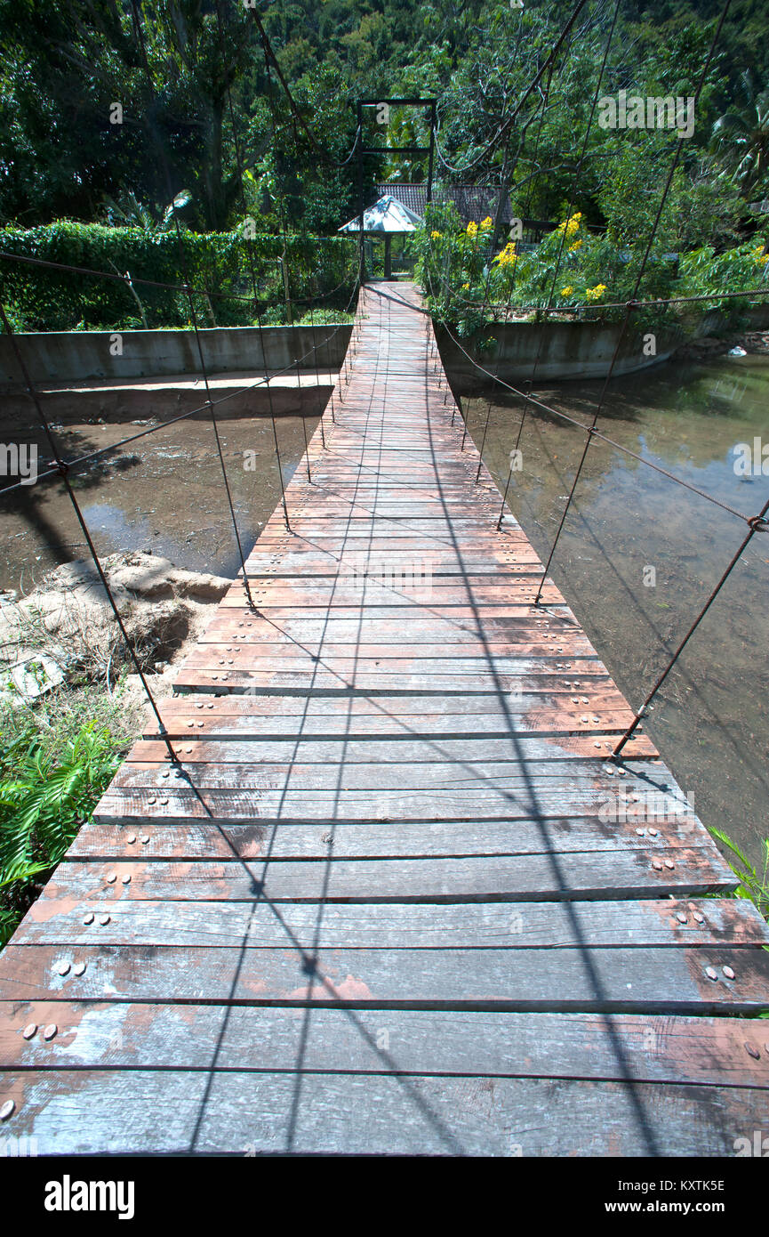 Wire hanging bridge with wooden pathway in Thailand Stock Photo - Alamy