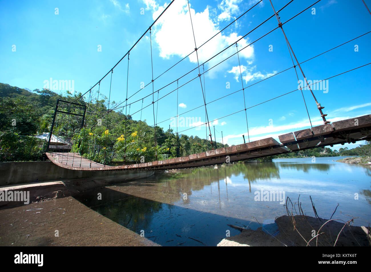Wire hanging bridge with wooden pathway in Thailand Stock Photo - Alamy