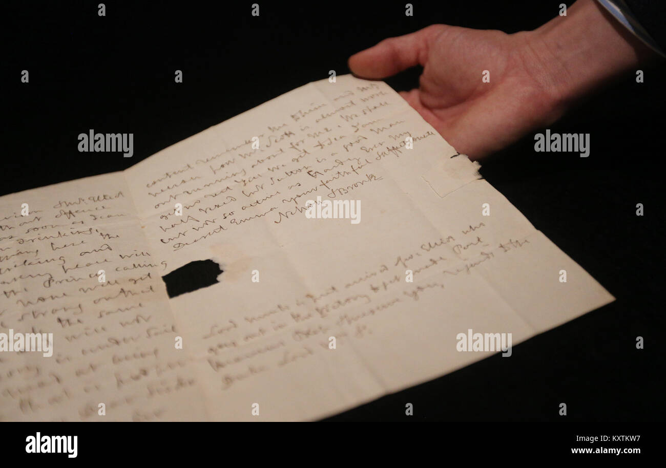 A gallery employee handles a signed letter from Lord Nelson to Lady ...