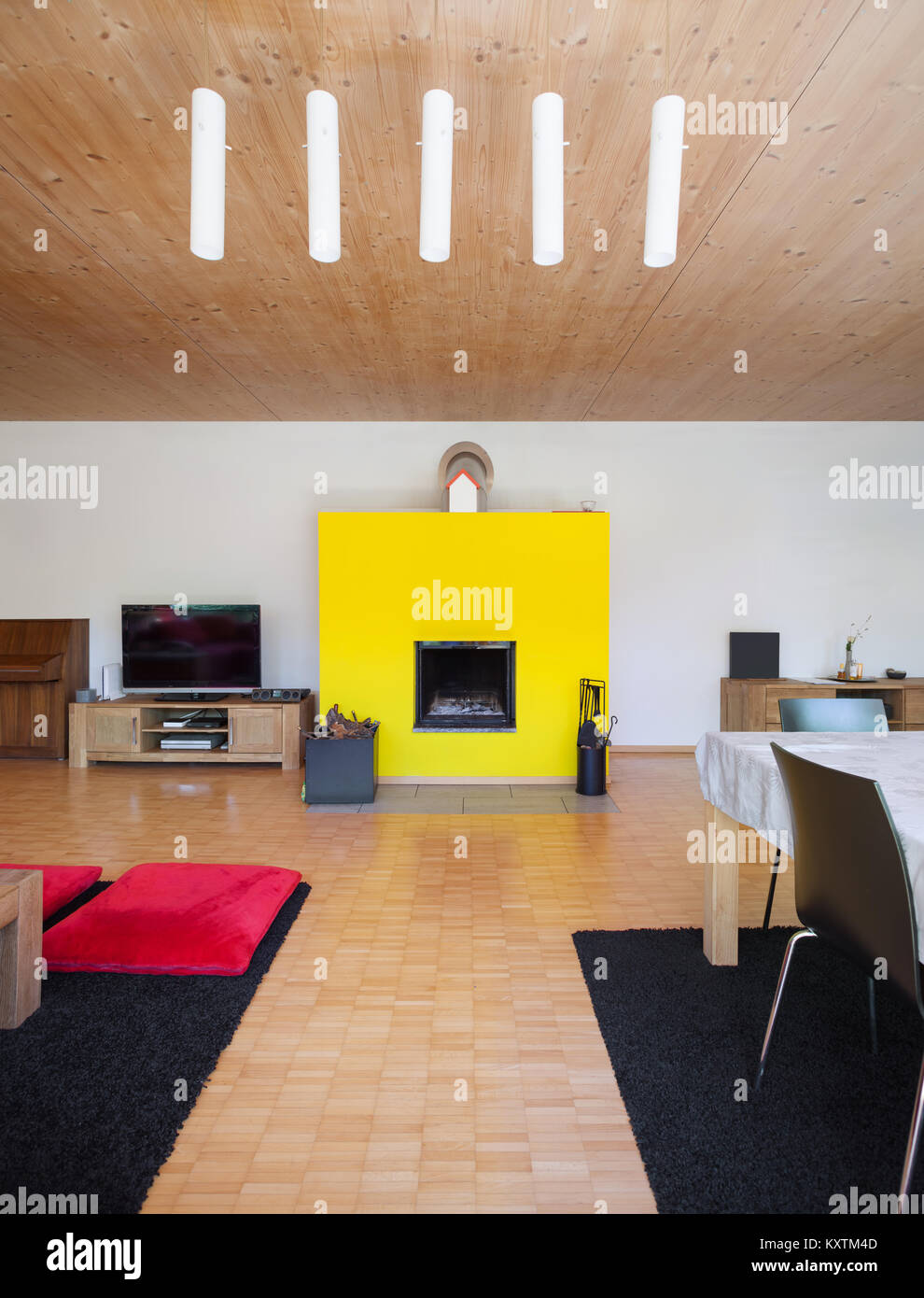 Interior of an eco house, living room with yellow fireplace Stock Photo ...