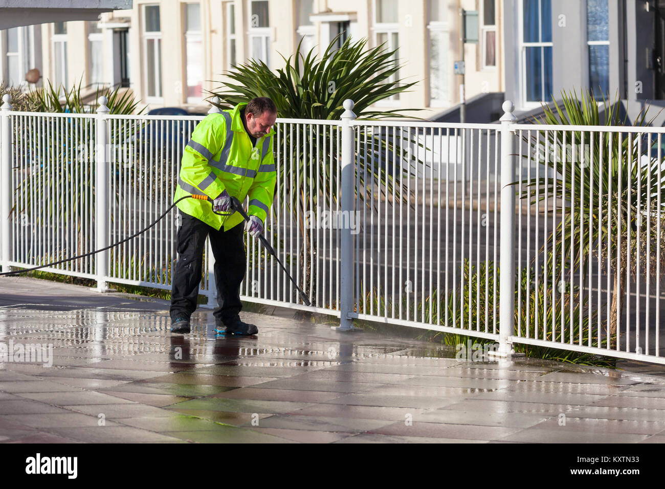 Local council worker pressure sprays the promenade to keep it clean and ...