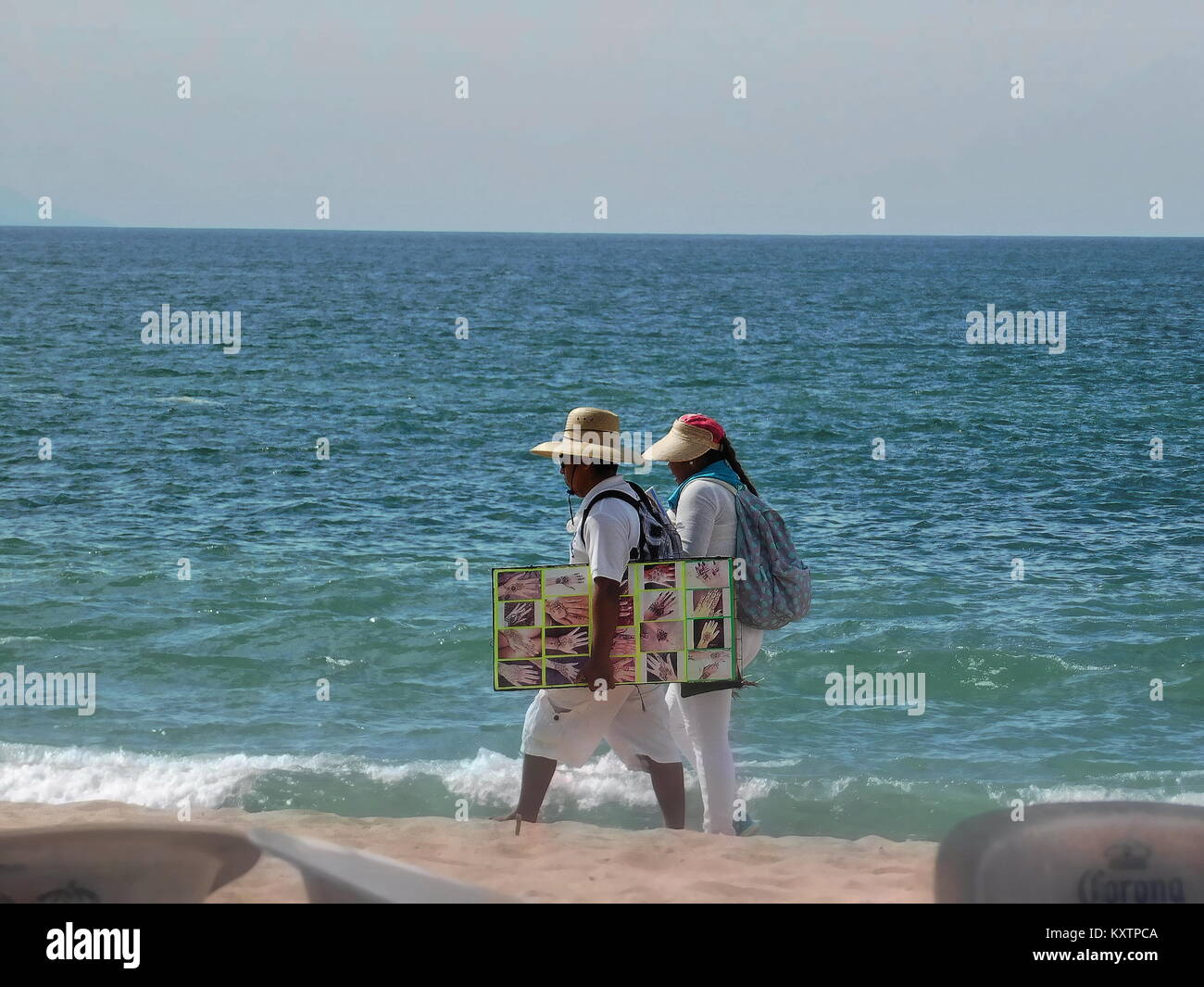 Merchants Walking along Beach Selling their Wares Stock Photo - Alamy