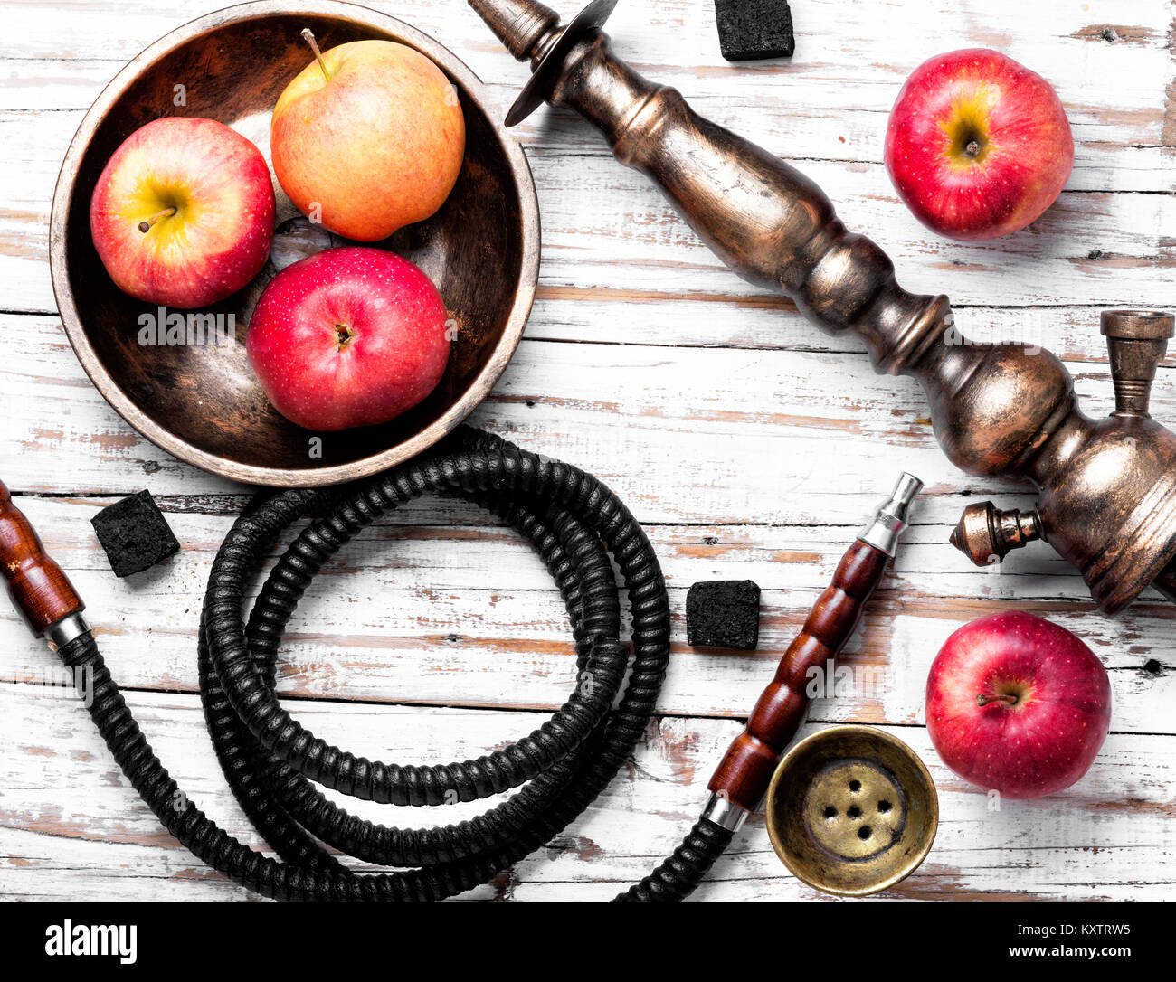Smoking smoking shisha in east style with tobacco aroma of red apple ...