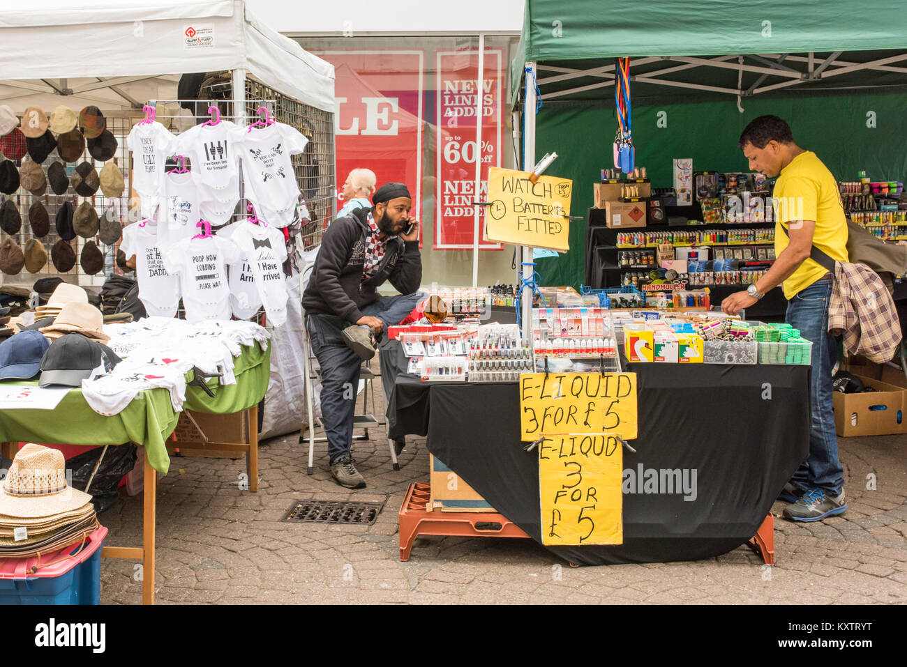 Market day in Ramsgate town centre. An asian trader selling various ...