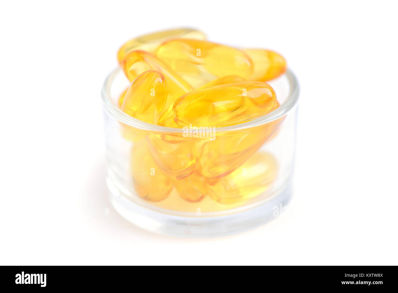 Omega-3 capsules in a glass on white background Stock Photo - Alamy