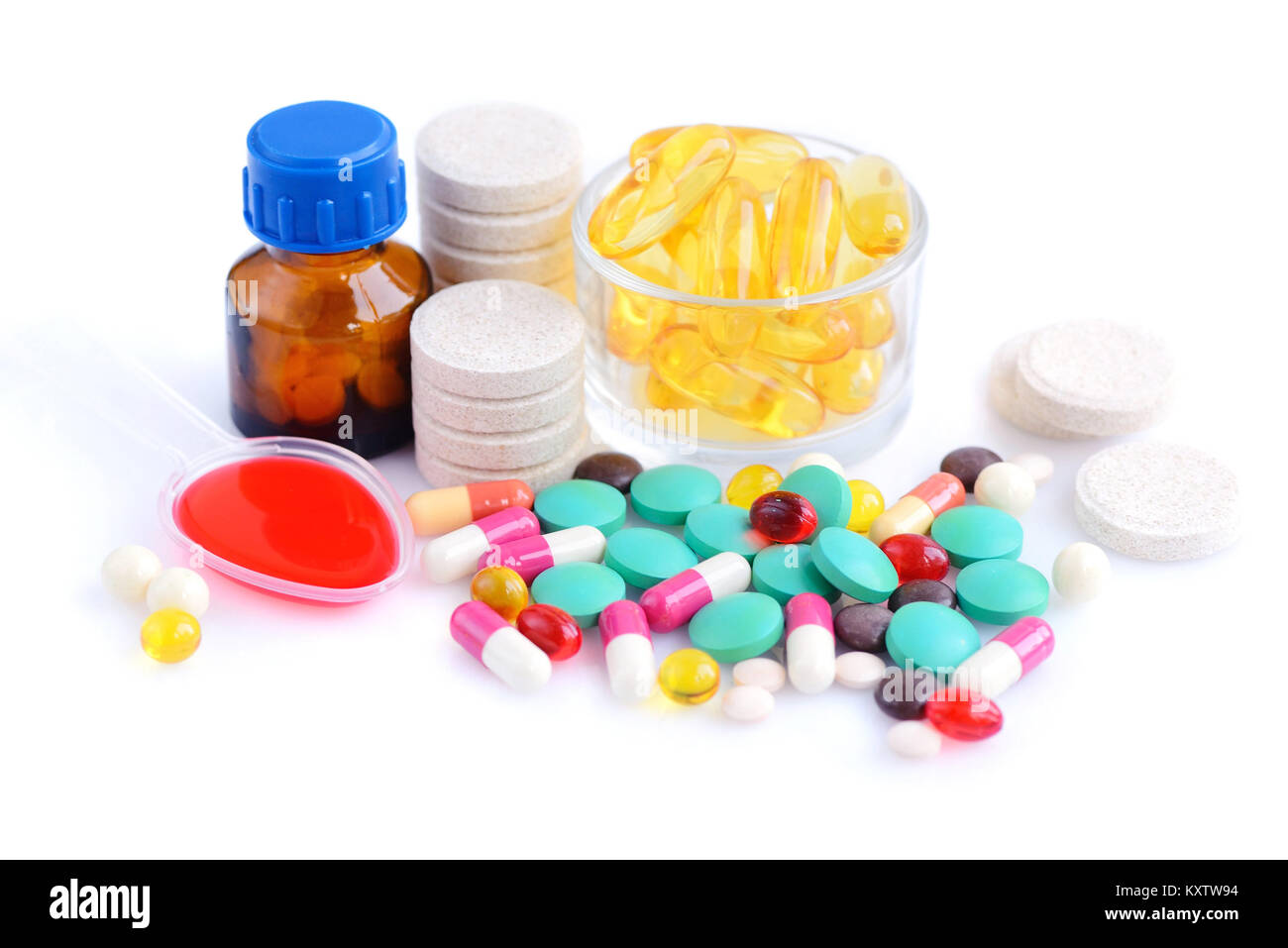 Colored pills, capsules and vitamins isolated on a white background ...