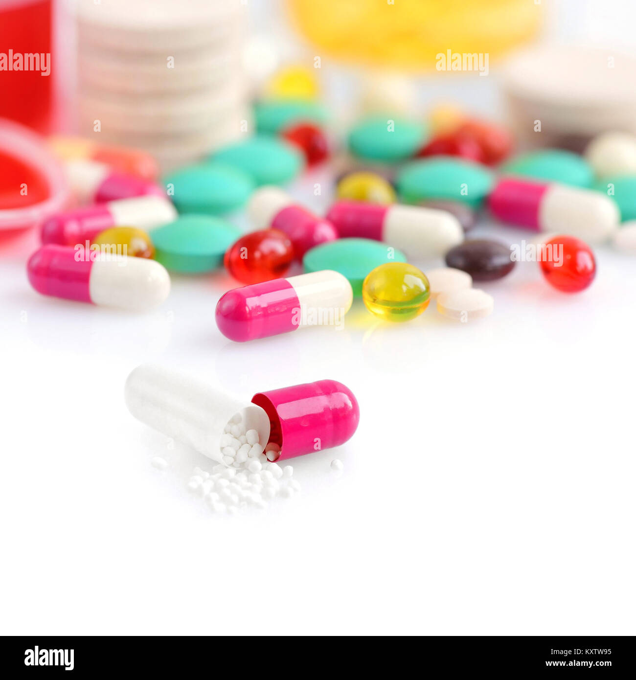 Colored pills, capsules and vitamins isolated on a white background ...