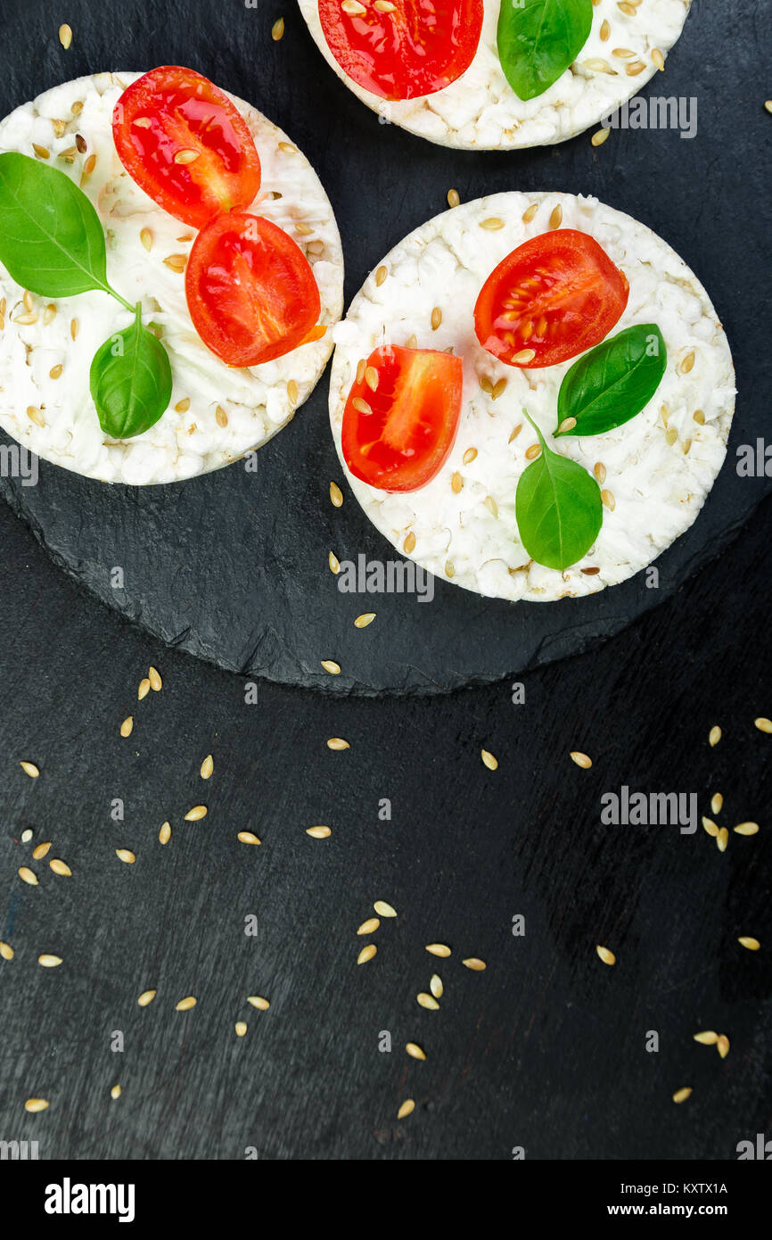 Healthy Rice Cakes with cherry tomatoes, cheese feta, basil and sesame ...