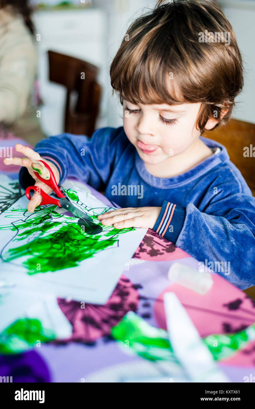 children paint and draw and cut out drawings made by them at the ...