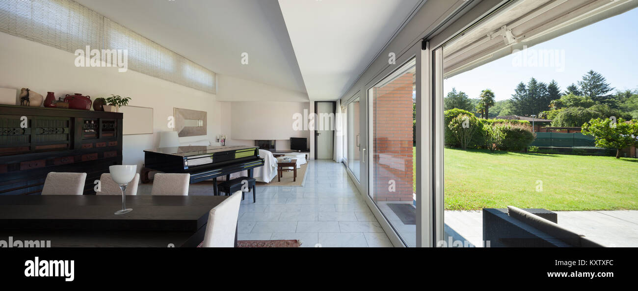 Lounge of a modern house, big windows, interior Stock Photo - Alamy