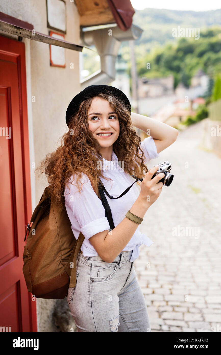 Beautiful young tourist with camera in the old town Stock Photo - Alamy
