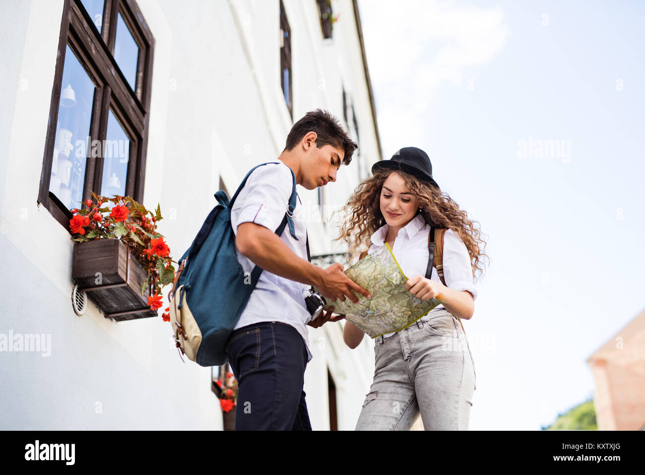 Two young tourists with map and camera in the old town Stock Photo - Alamy