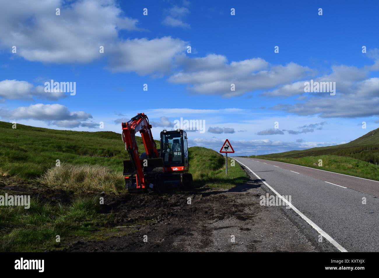 Highland road, tractor and deer sign Stock Photo - Alamy