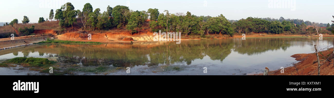 Panorama of pond with water near farm fields Stock Photo - Alamy