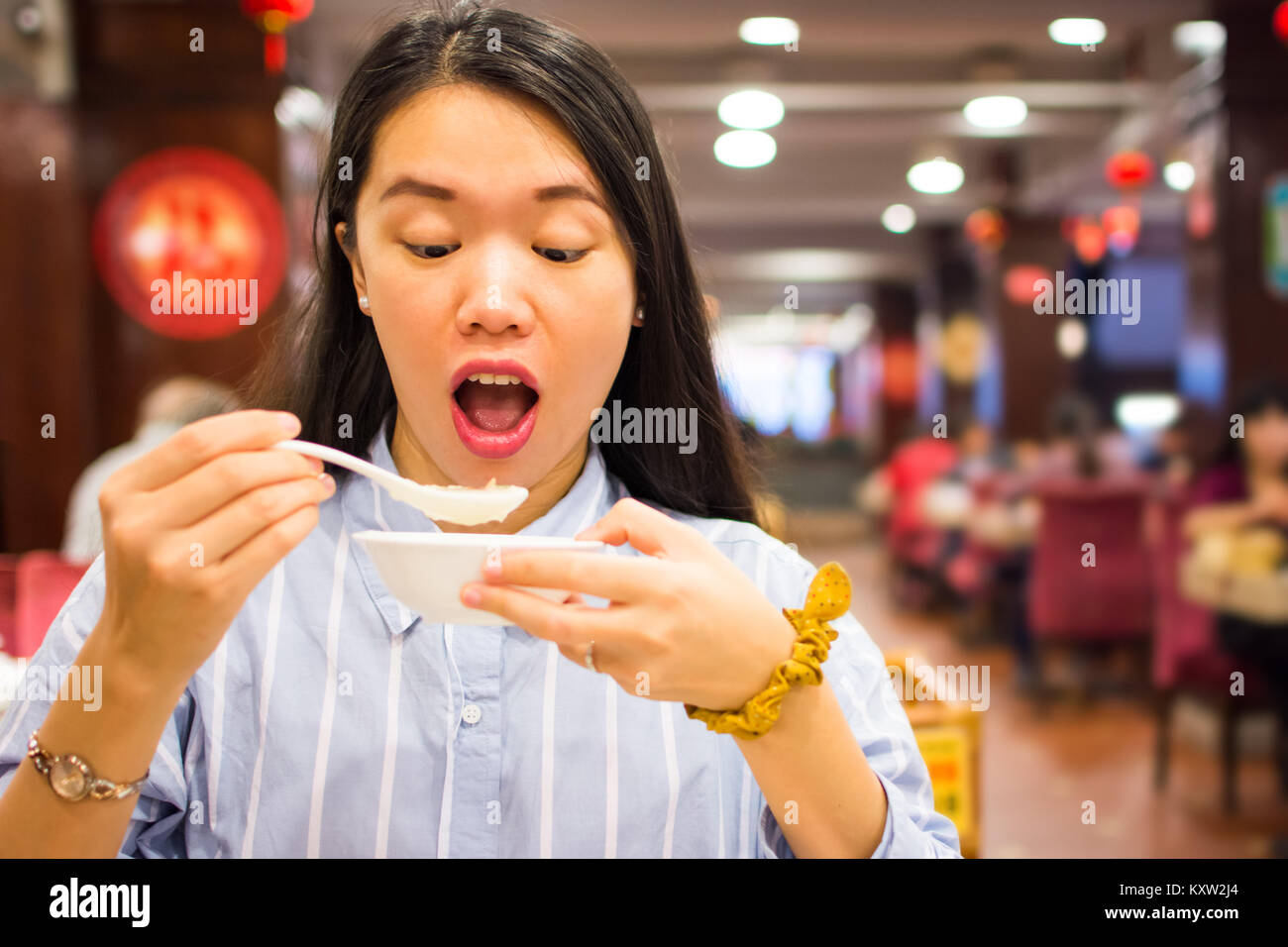 Happy asian woman enjoying Chinese food in Chinese restaurant Stock ...